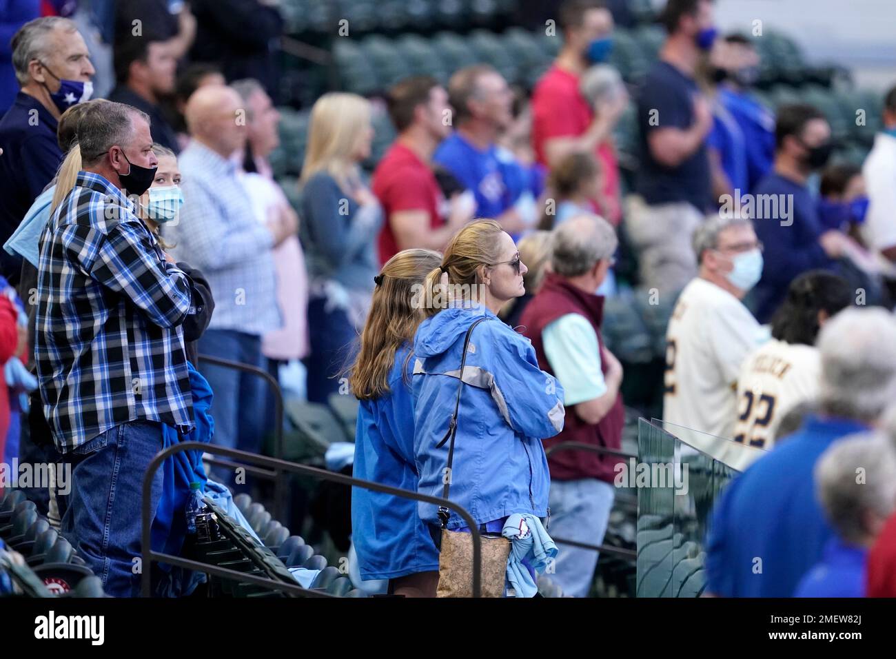 Fans stand for the playing of the national anthem before the start of a ...