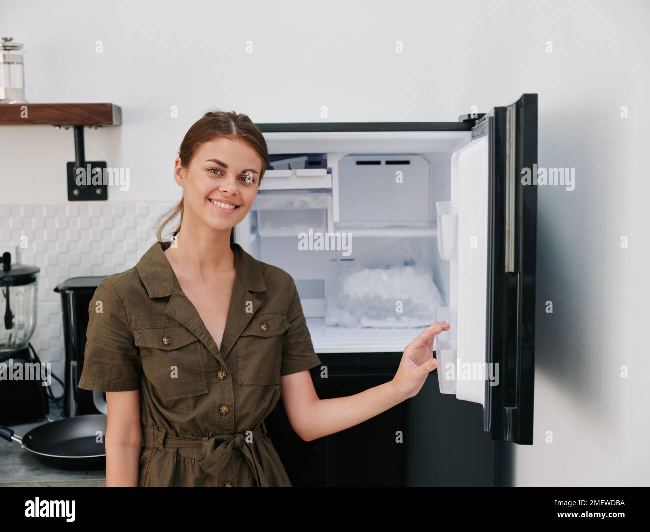 Woman putting food in freezer hi-res stock photography and images - Alamy