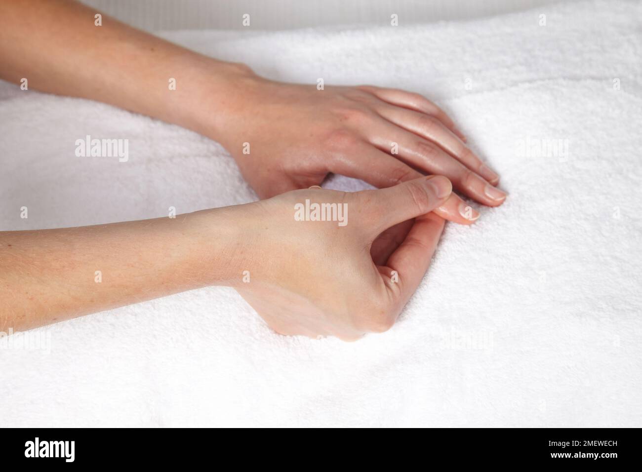 Hand massage pulling finger 3 Stock Photo - Alamy