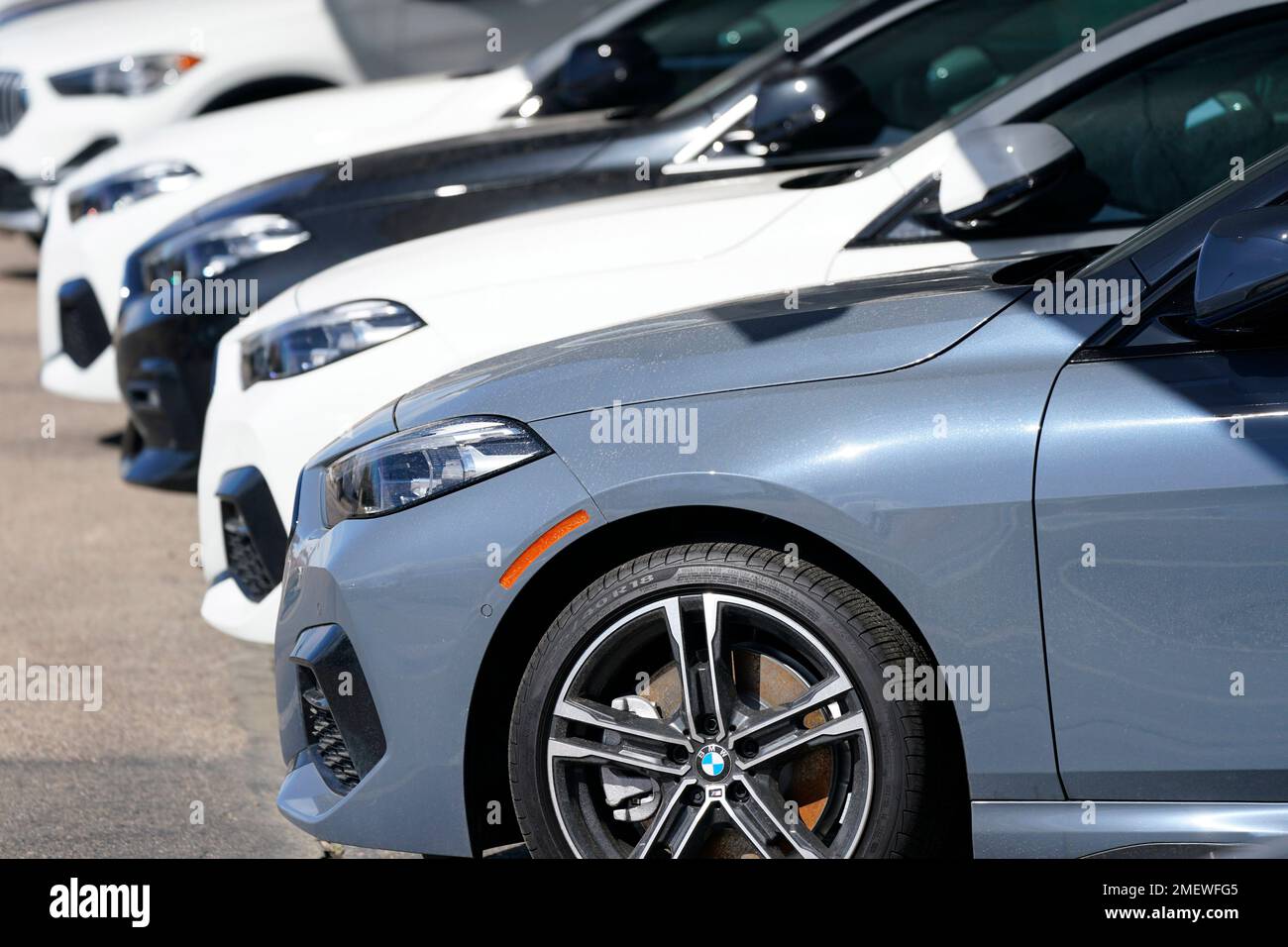 A long row of unsold 2021 228i sedans sits at a BMW dealership Sunday ...