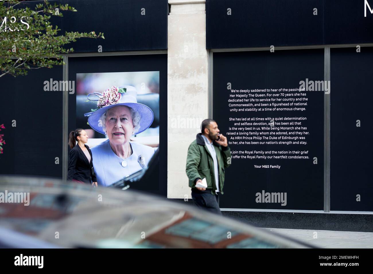 A Pedestrian Walks Past A Portrait Of Queen Elizabeth Ii Displayed On