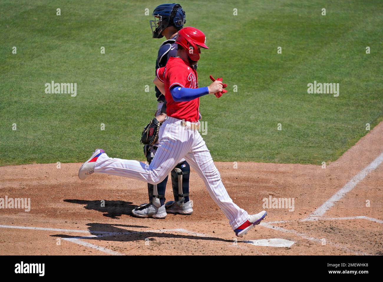 Philadelphia Phillies' Bryce Harper, front, crosses home plate in front ...