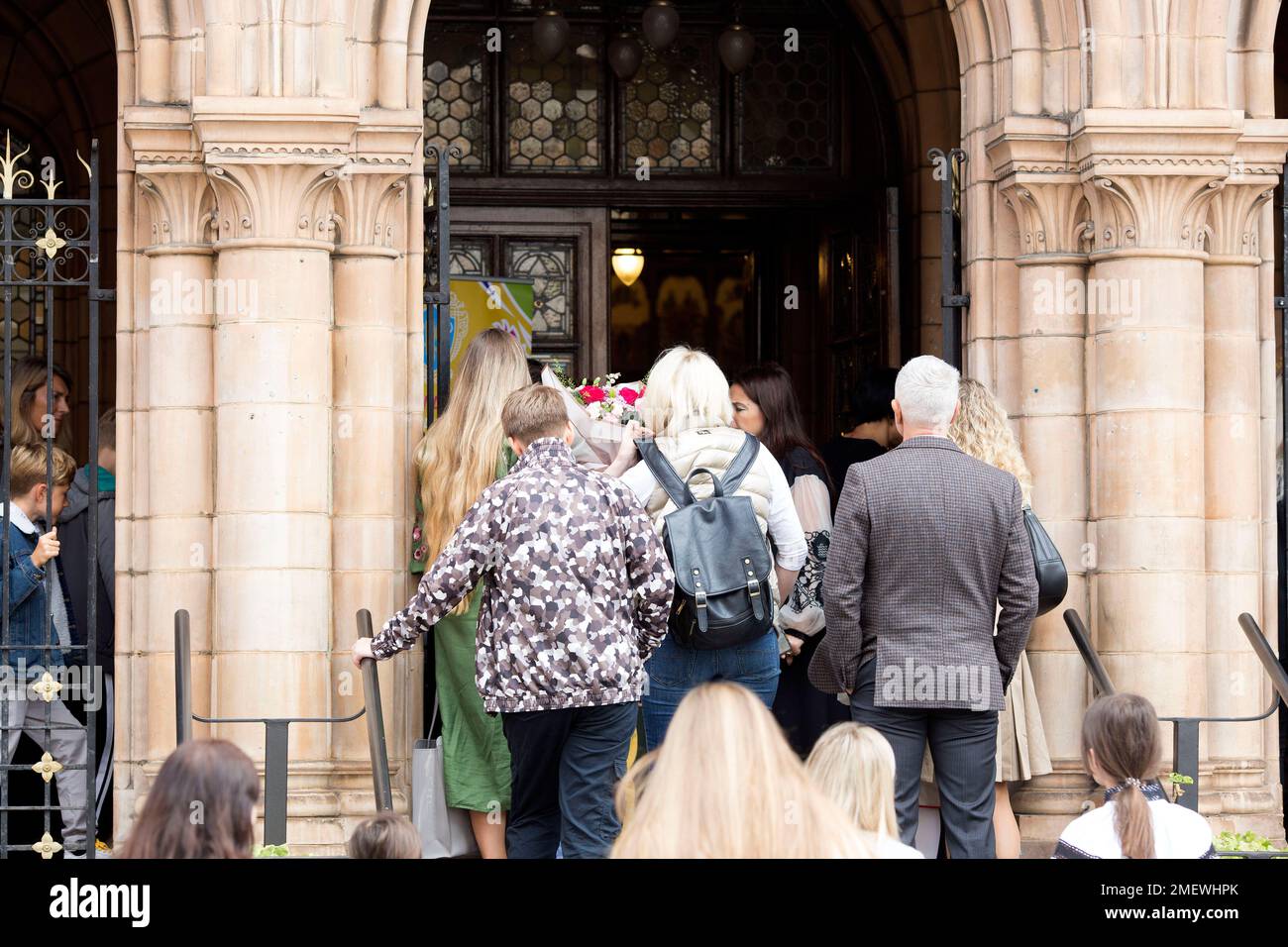 People gather to enter a building in central London Stock Photo - Alamy