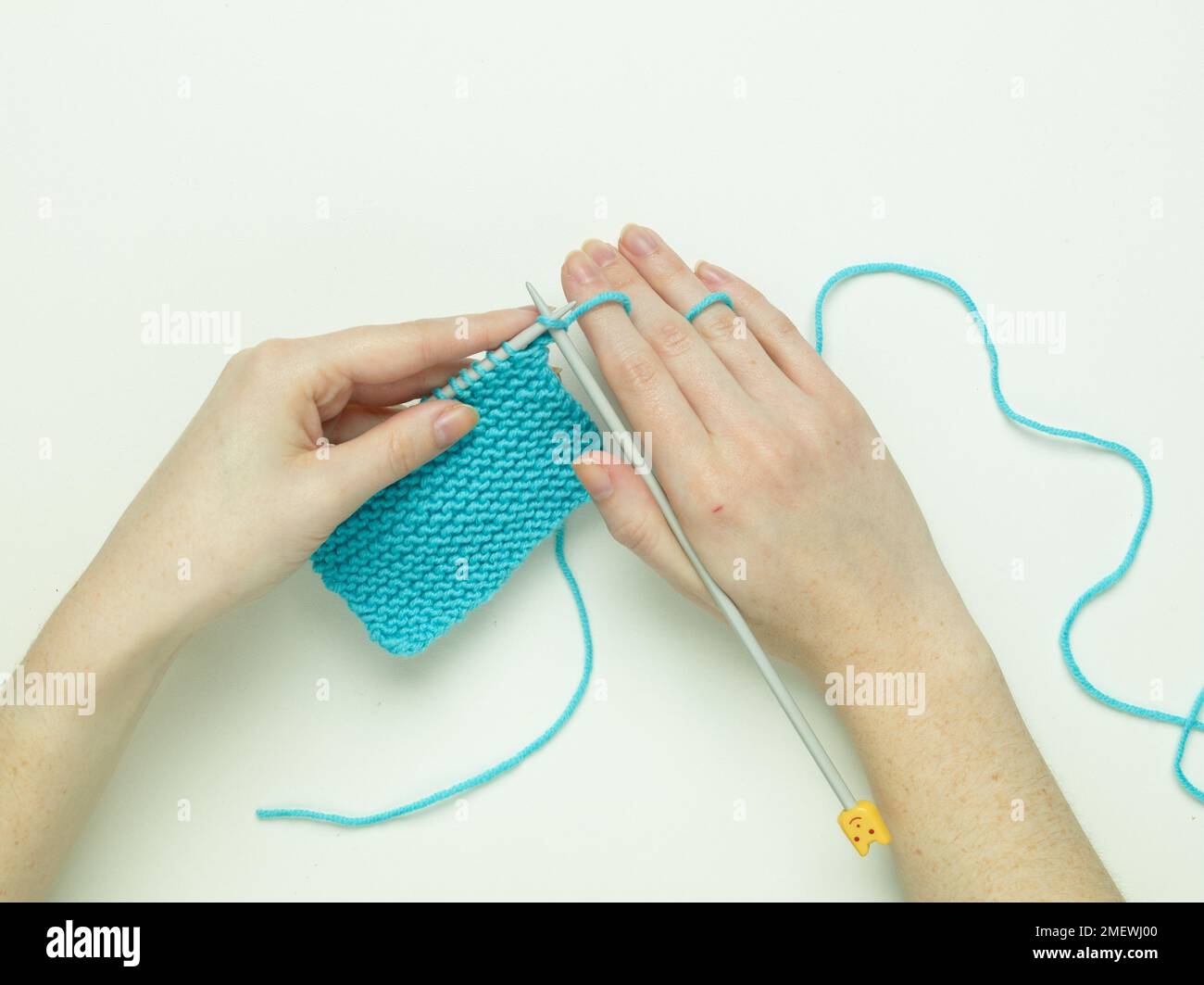 Showing knitting garter stitch with blue yarn Stock Photo - Alamy