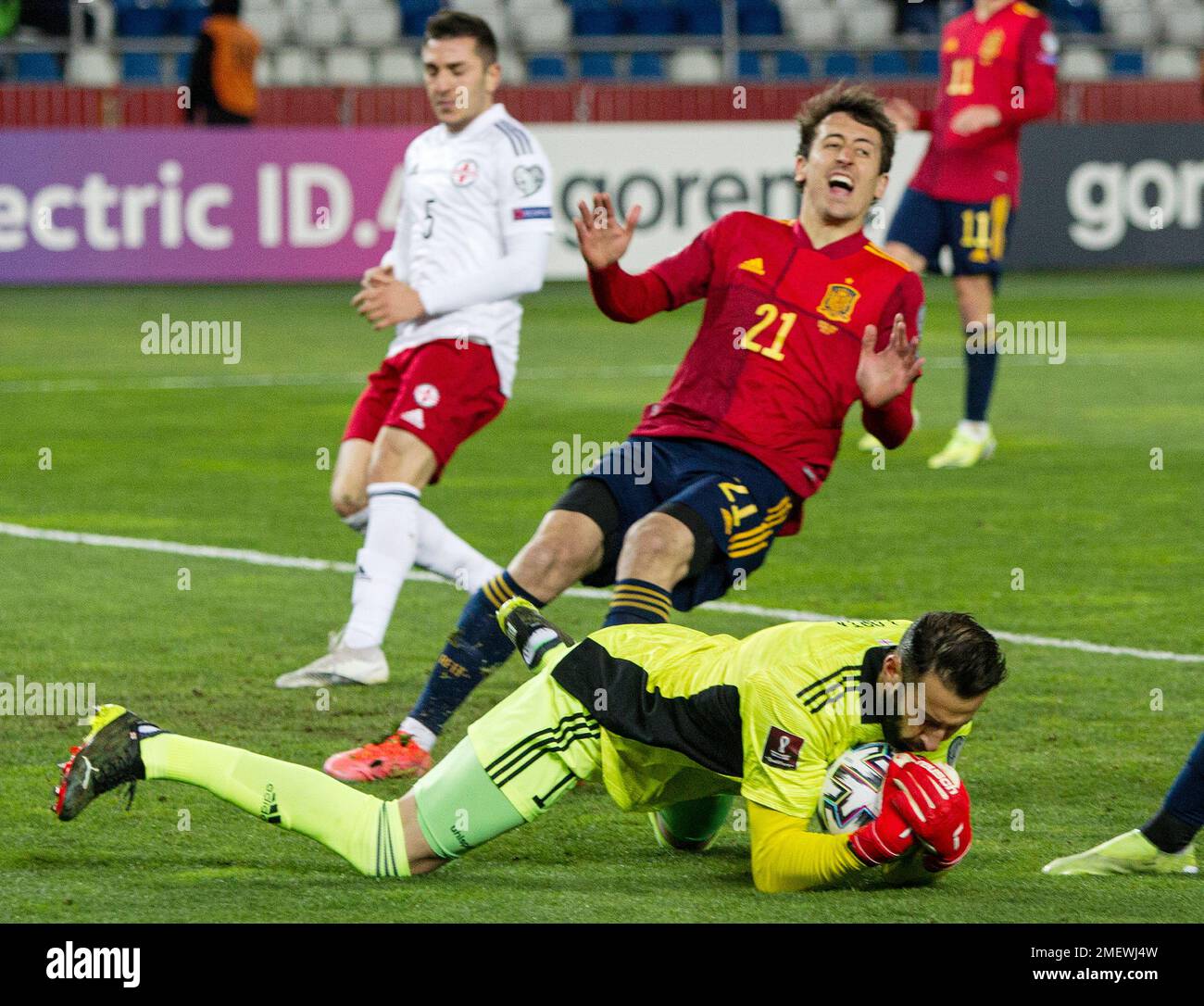 Georgia's goalkeeper Giorgi Loria, bottom, saves a ball as Spain's ...