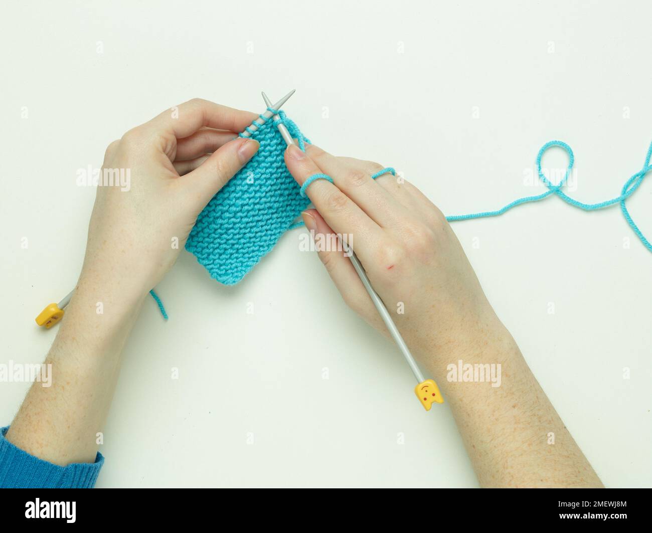 Showing knitting garter stitch with blue yarn Stock Photo - Alamy