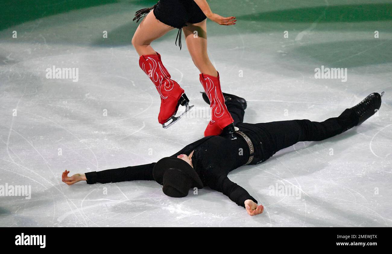 Madison Chock wears red skating boots as she performs with partner Evan ...