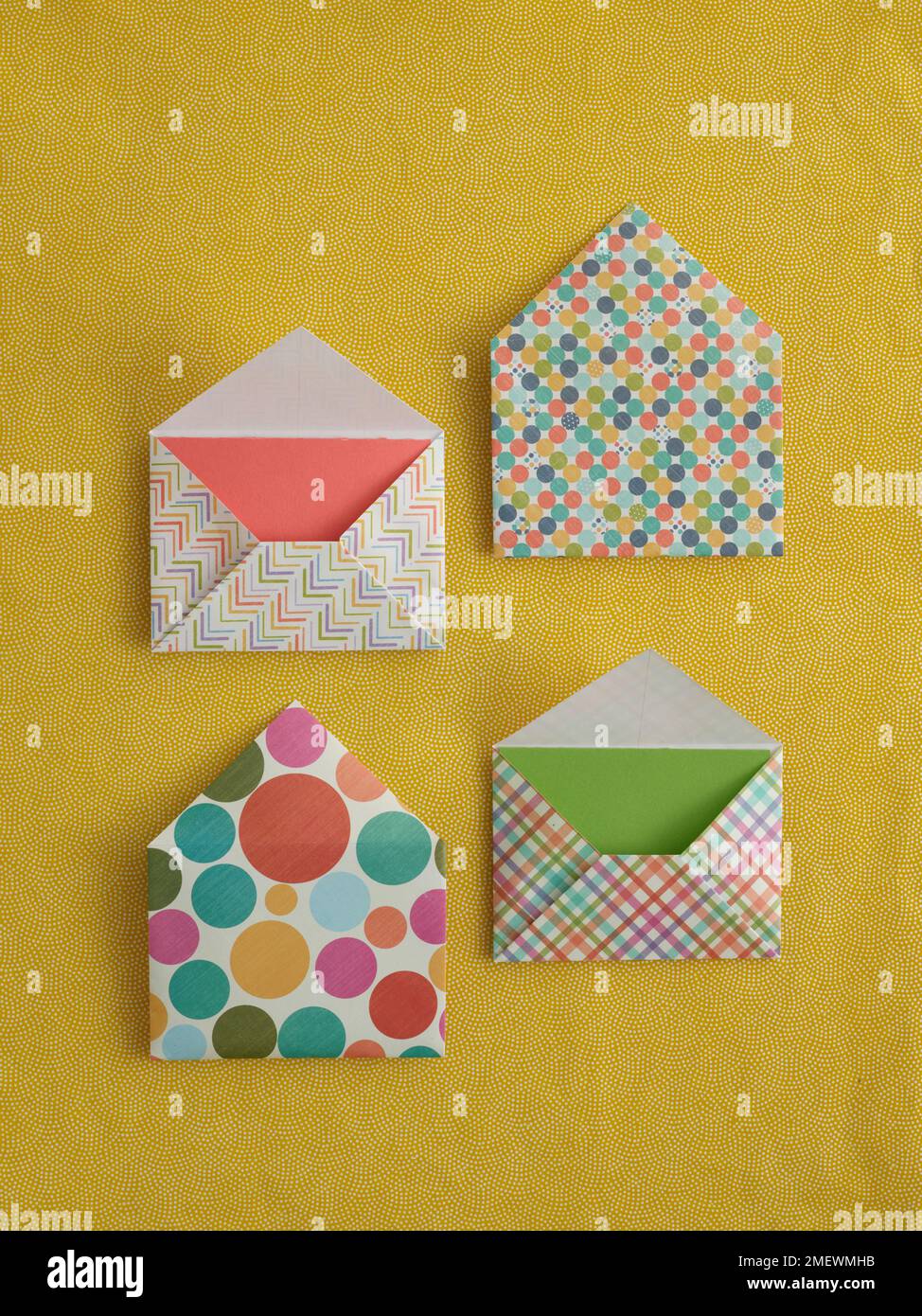 Papercraft. DIY Envelopes on yellow patterned background Stock Photo ...