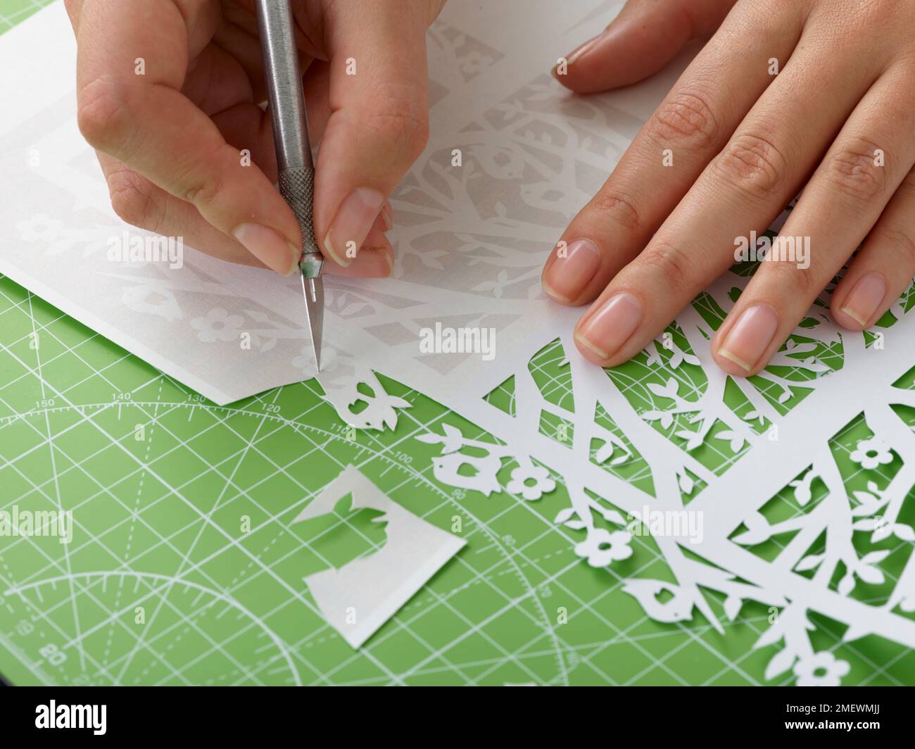 Papercraft. DIY Paper Lantern, cutting out pattern with scalpel Stock ...