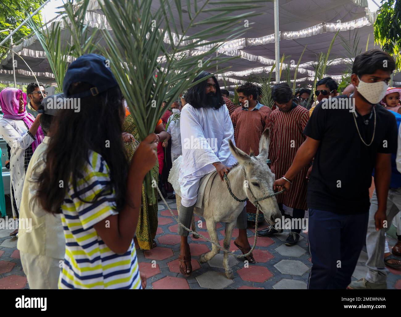 An Indian Christian devotee dressed like Jesus Christ sits on a donkey ...