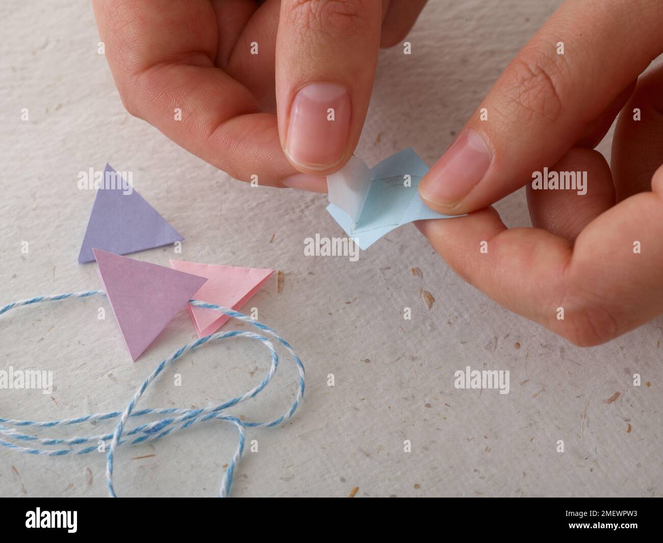 Papercraft. Paper bunting step 2. Peeling off double sided tape backing ...