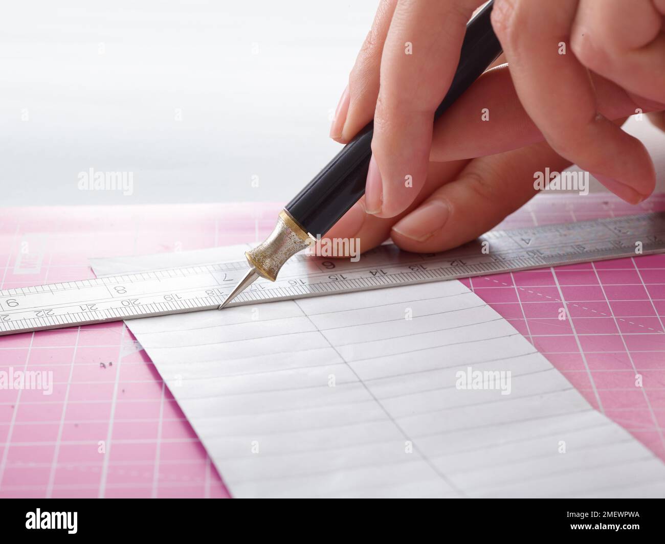 Papercraft. DIY accordian fold step 1. Scoring your paper Stock Photo ...