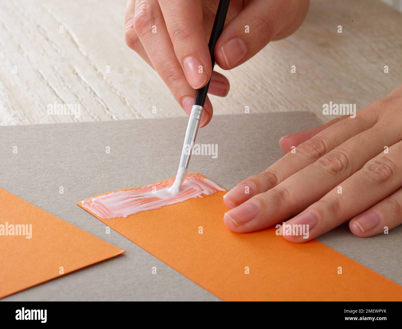 Papercraft. DIY animal mask. Step 1 adding PVA to paper strip Stock ...