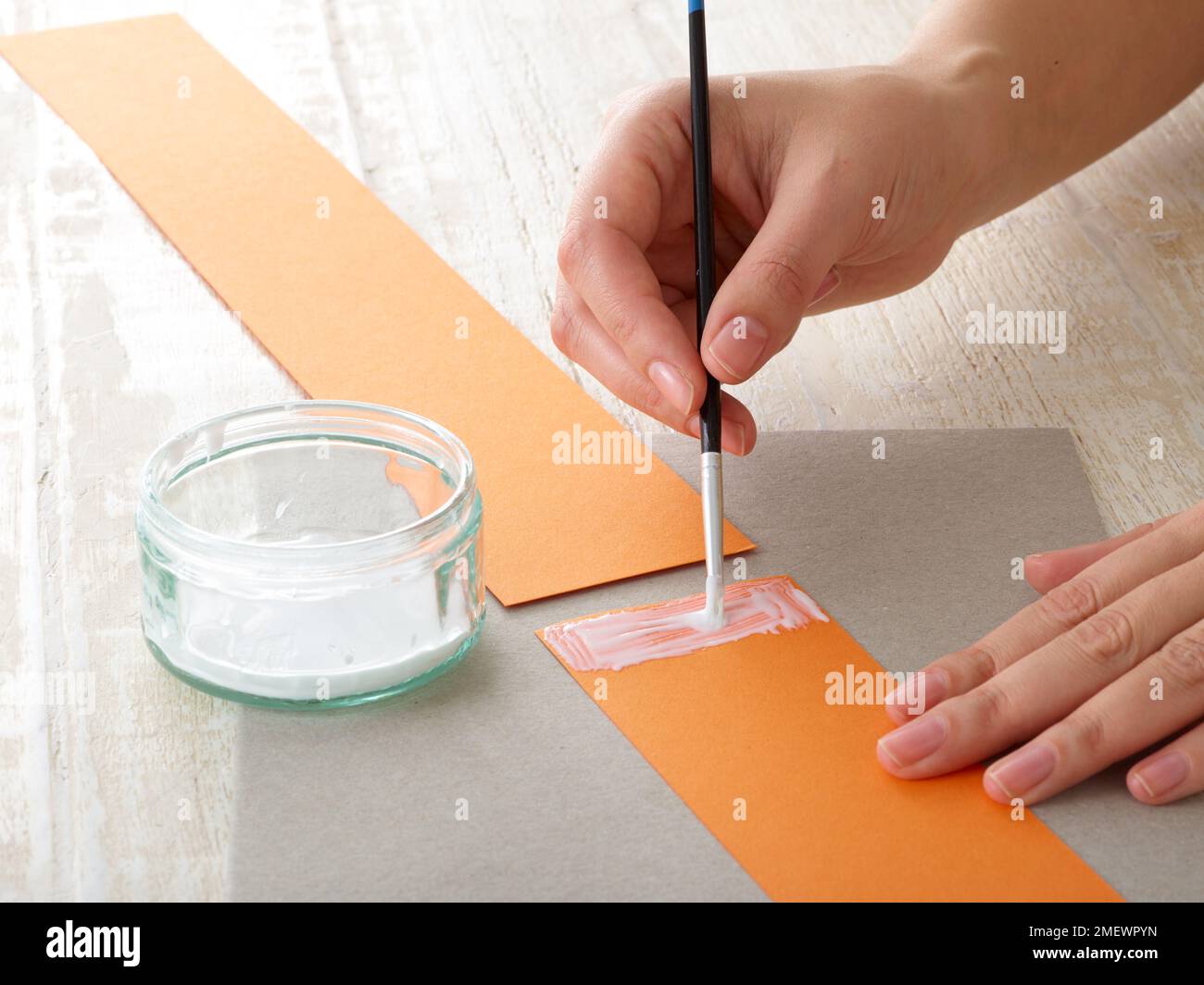 Papercraft. DIY animal mask. Step 1 adding PVA to paper strip Stock ...