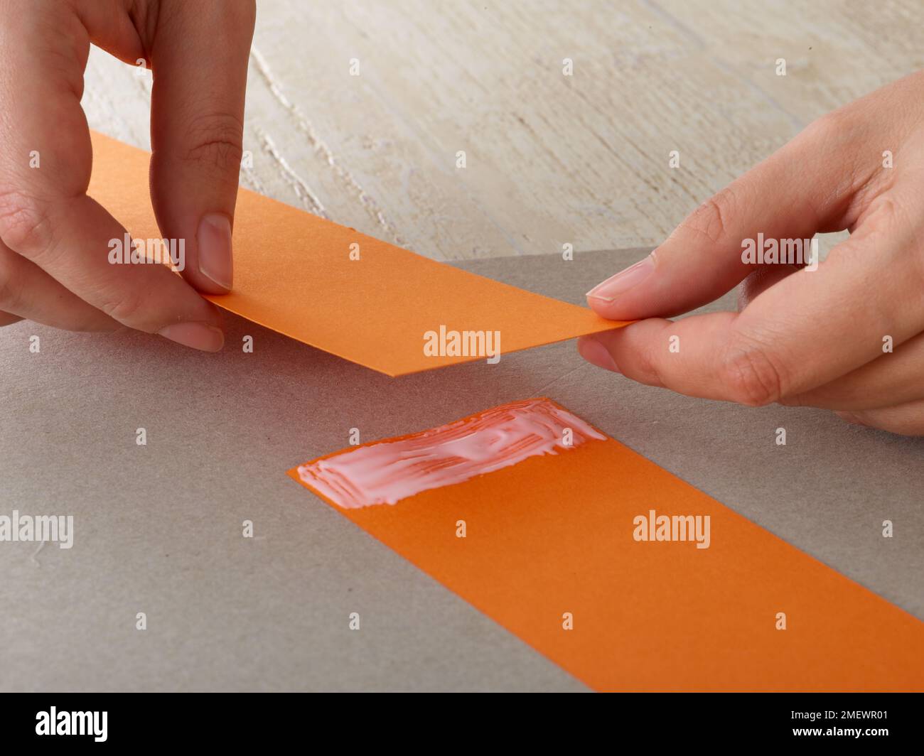 Papercraft. DIY animal mask. Step 2 attaching two paper strips Stock ...