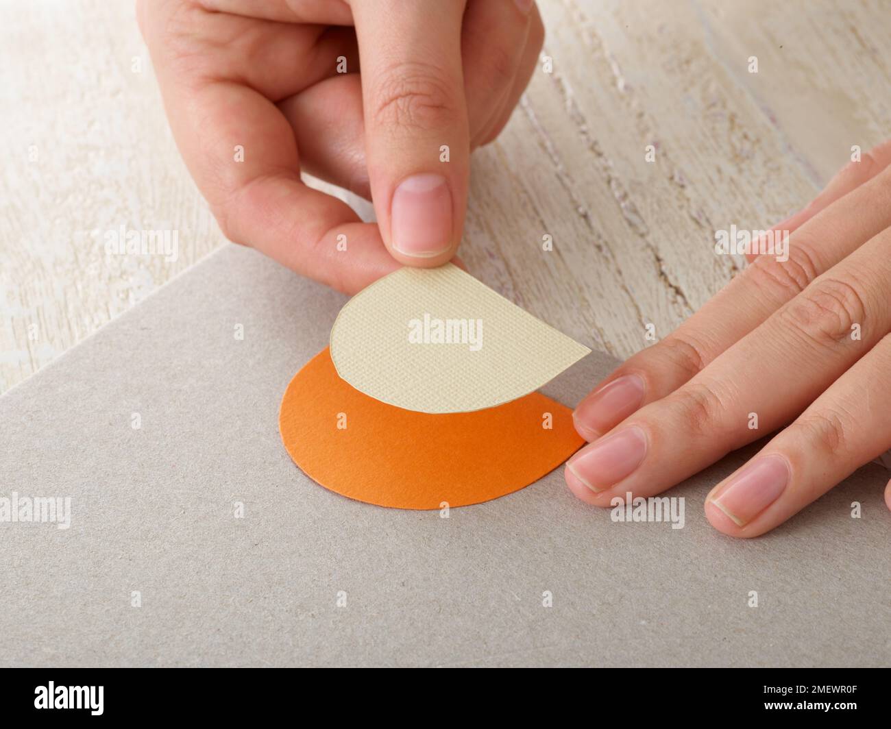 Papercraft. DIY animal mask. Step 5 creating bear ears Stock Photo - Alamy