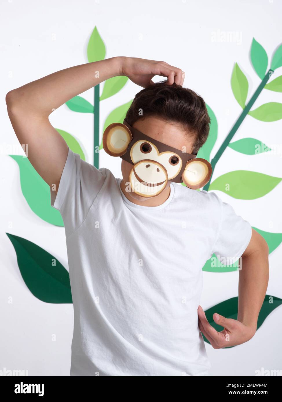 Papercraft. DIY Animal masks. Child in white tshirt wearing Monkey mask ...