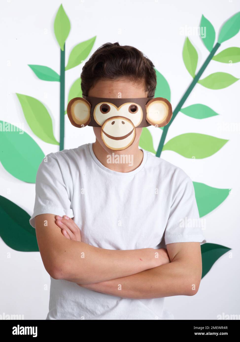 Papercraft. DIY Animal masks. Child in white tshirt wearing Monkey mask ...