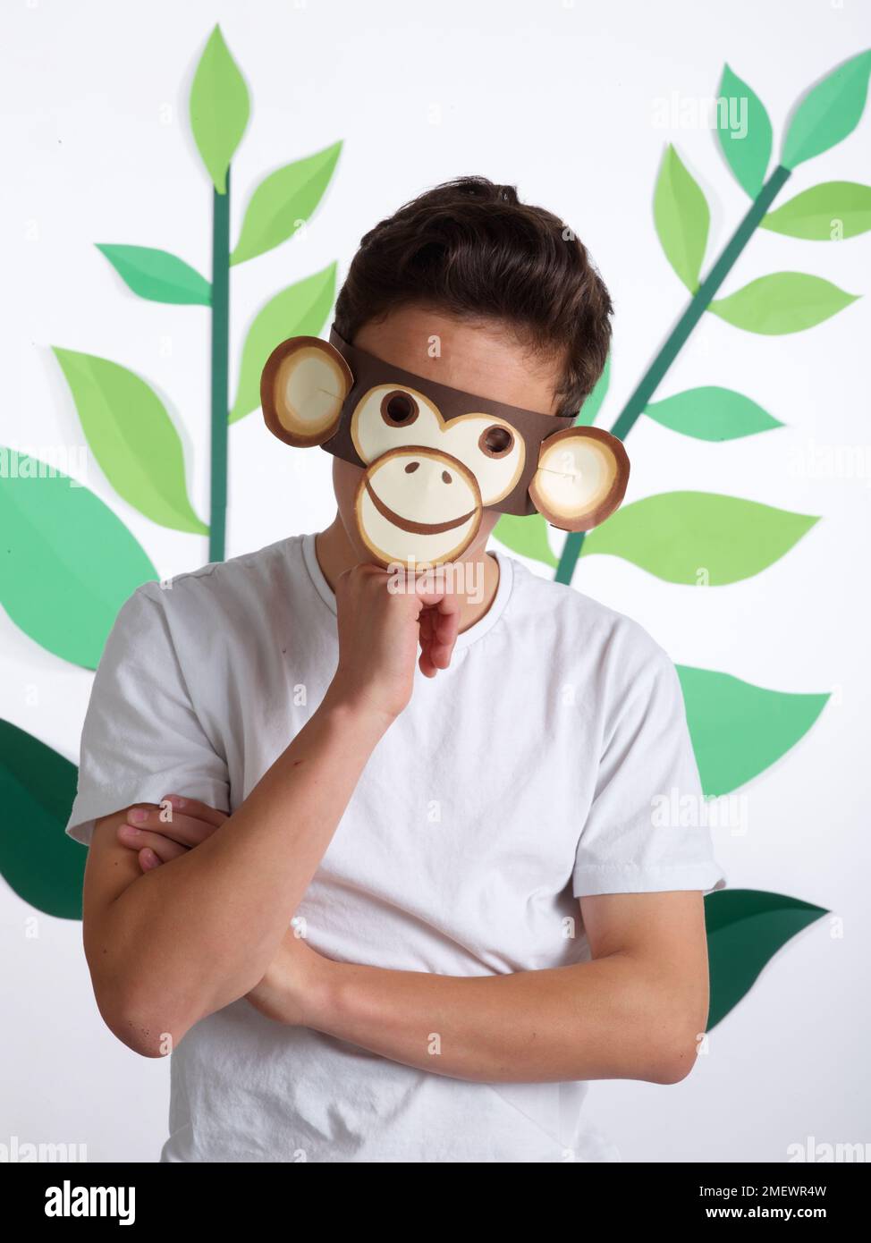 Papercraft. DIY Animal masks. Child in white tshirt wearing Monkey mask ...