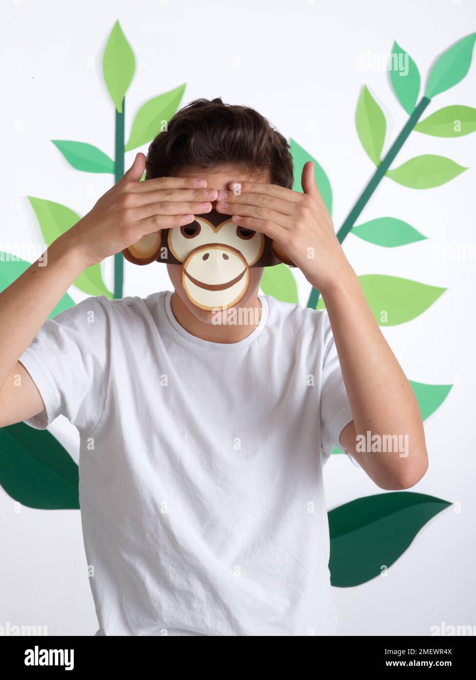 Papercraft. DIY Animal masks. Child in white tshirt wearing Monkey mask ...