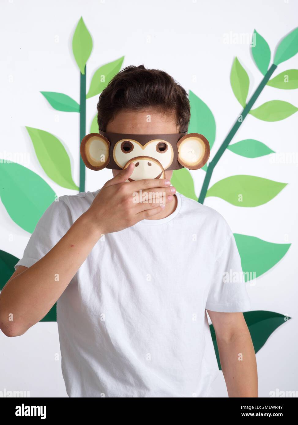 Papercraft. DIY Animal masks. Child in white tshirt wearing Monkey mask ...