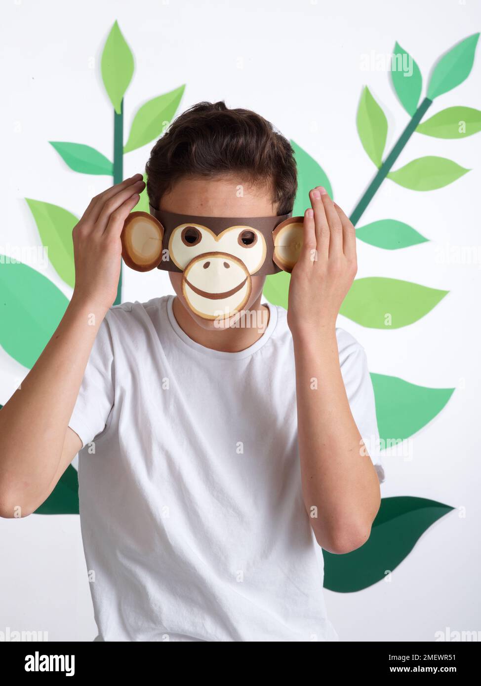 Papercraft. DIY Animal masks. Child in white tshirt wearing Monkey mask ...