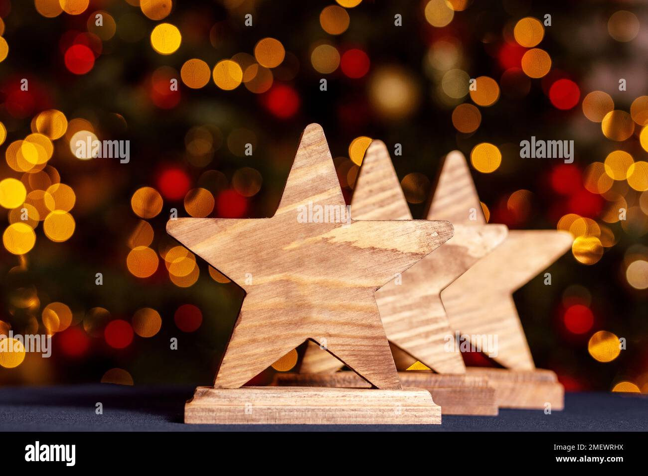 Wooden star for an award. Festive bokeh Stock Photo - Alamy