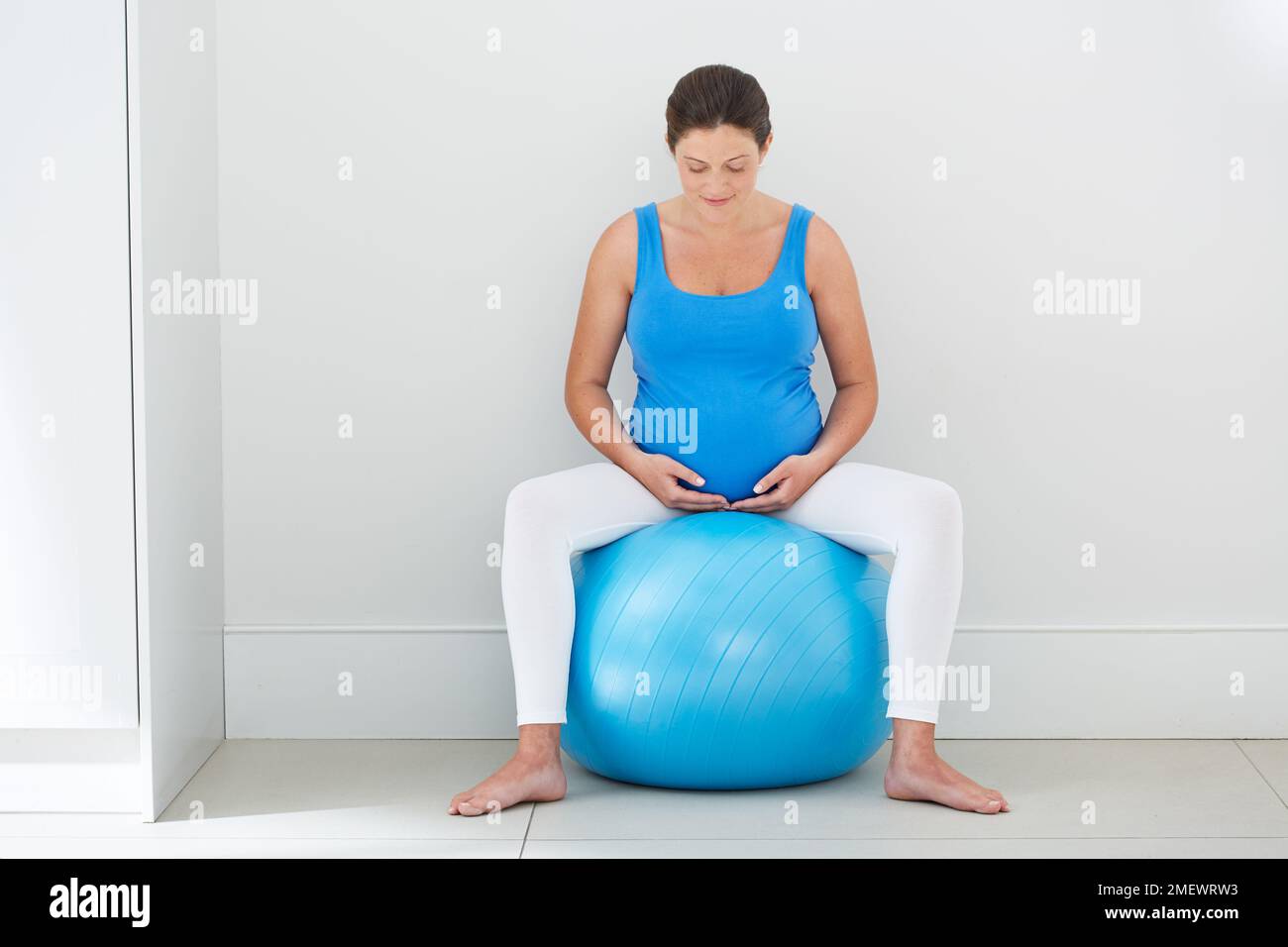 6 months / 26 weeks pregnant lady doing pelvic floor exercises with a ...