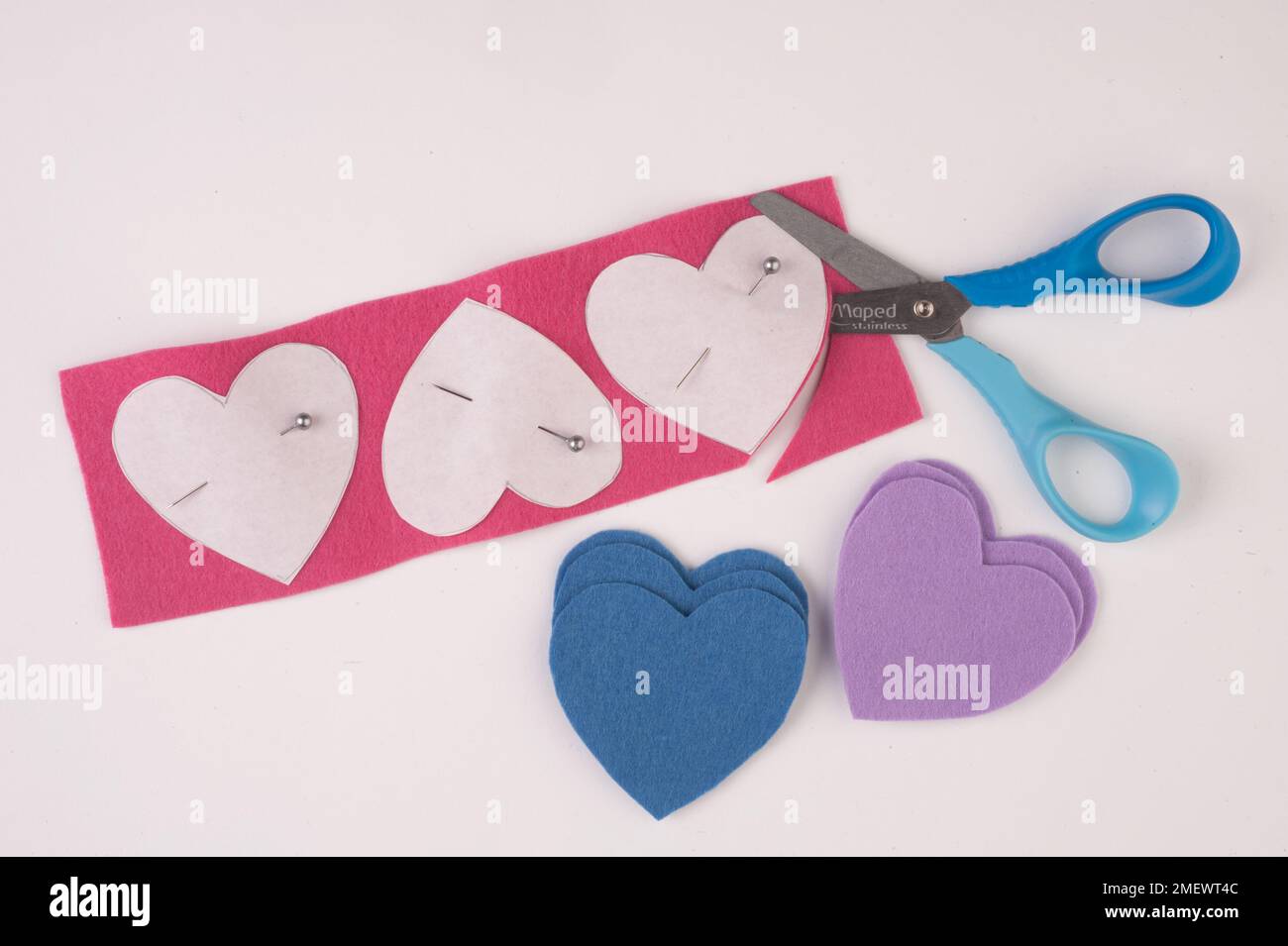 Cutting out heart shapes in felt for bunting Stock Photo - Alamy