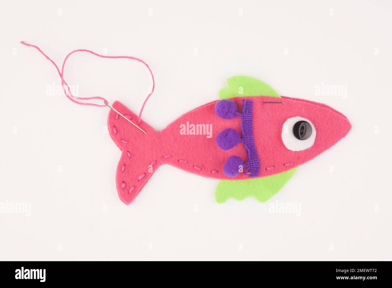 Sewing up felt fish with running stitch Stock Photo - Alamy