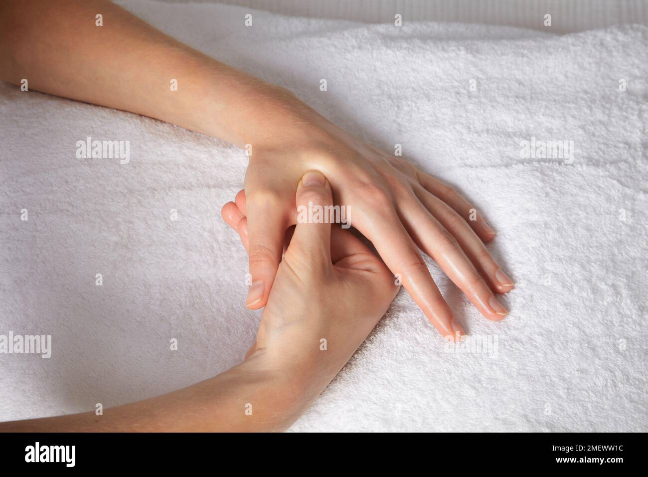 Hand massage between thumb Stock Photo - Alamy