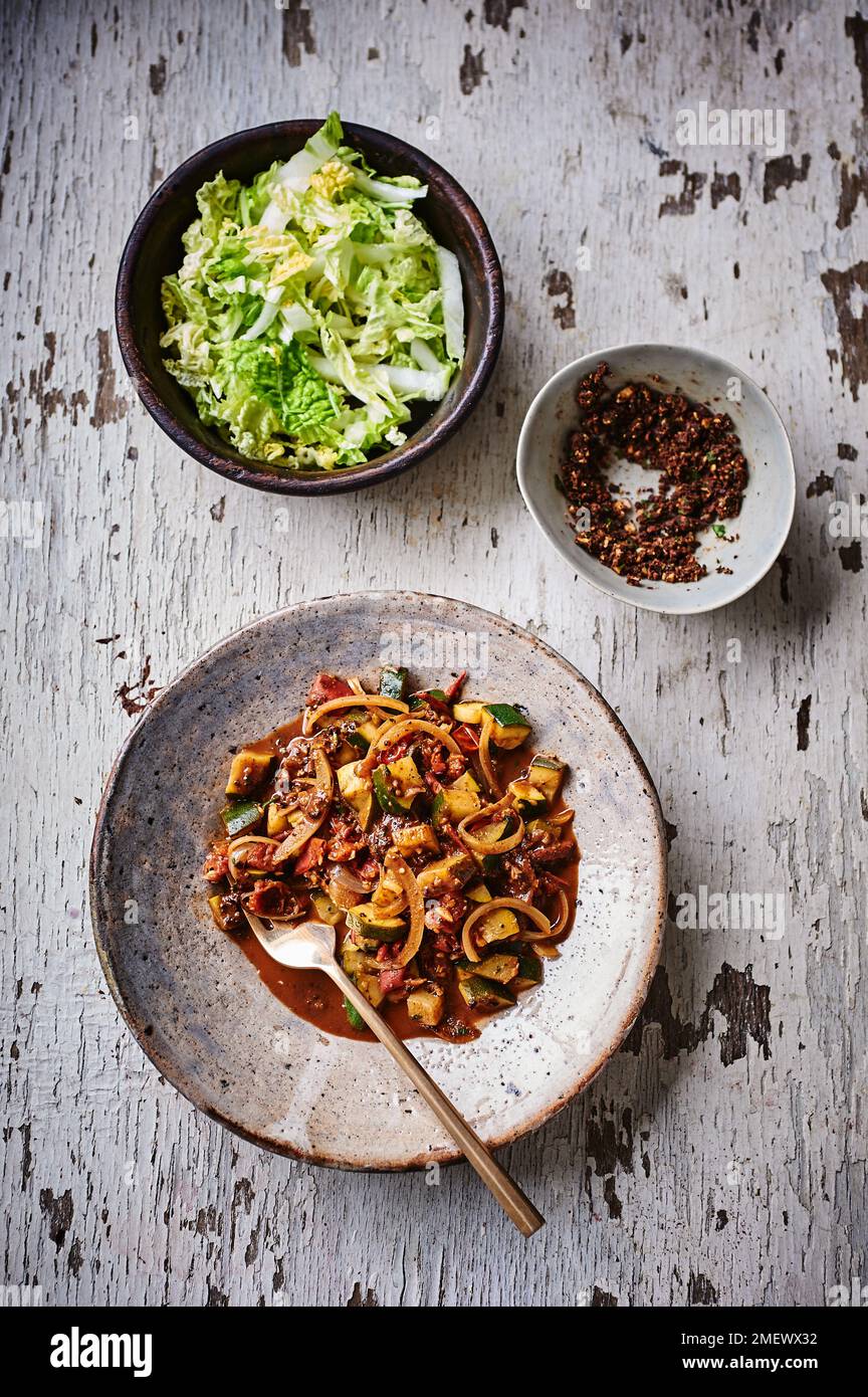Courgettes in Cuban-style tomato sofrito with cacao-almond picada Stock ...
