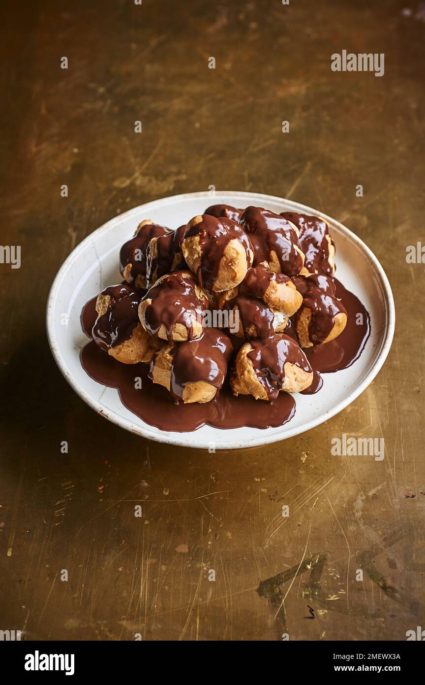 Chocolate profiteroles with Chantilly cream Stock Photo - Alamy