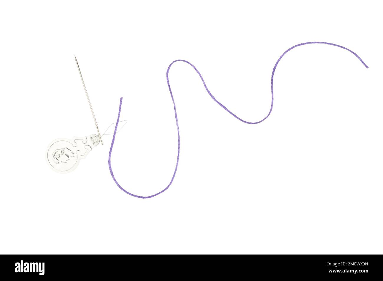 Threaded tapestry needle with needle threader Stock Photo - Alamy