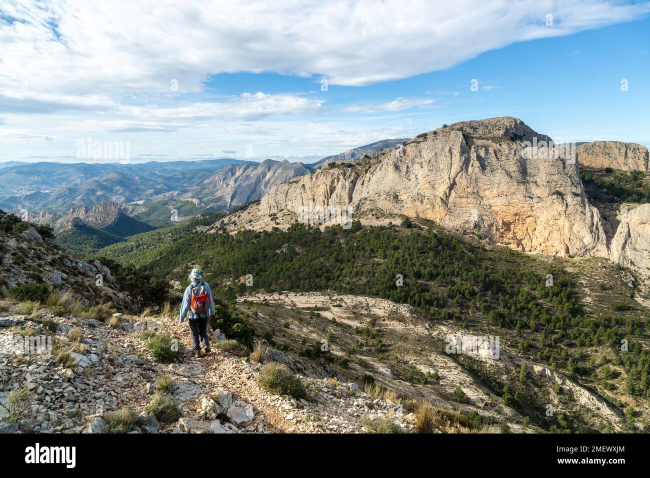A walker on the footpath from the mountain Ponotx / Ponoig with Penyo ...