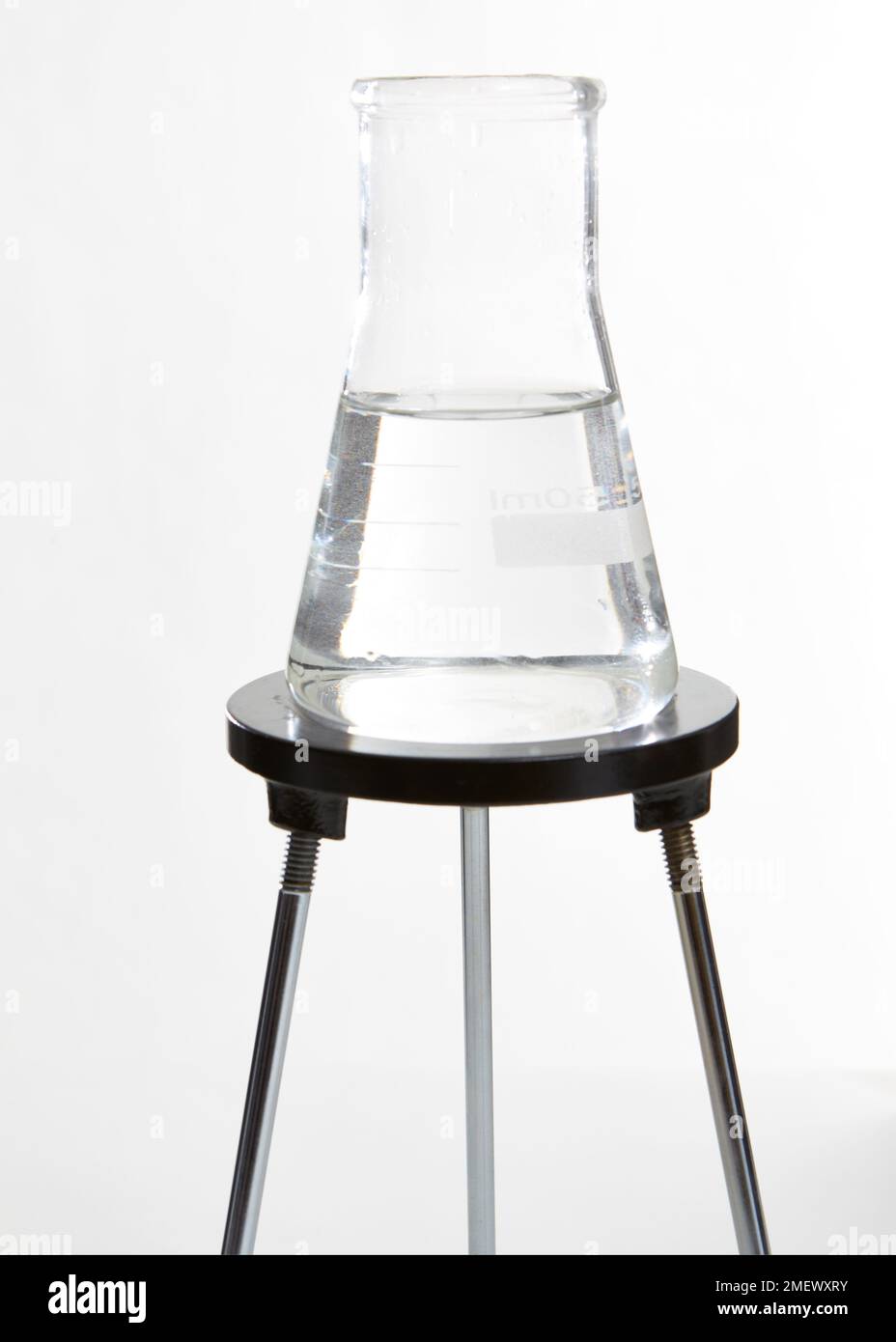 Glass conical flask on a tripod containing water Stock Photo - Alamy