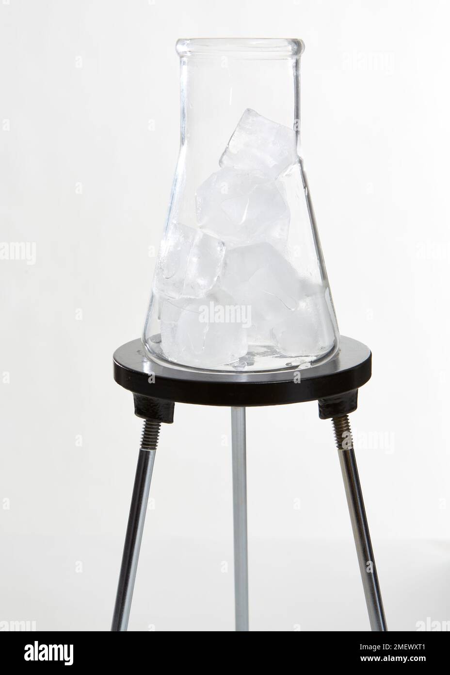 Glass conical flask on a tripod containing ice cubes Stock Photo - Alamy