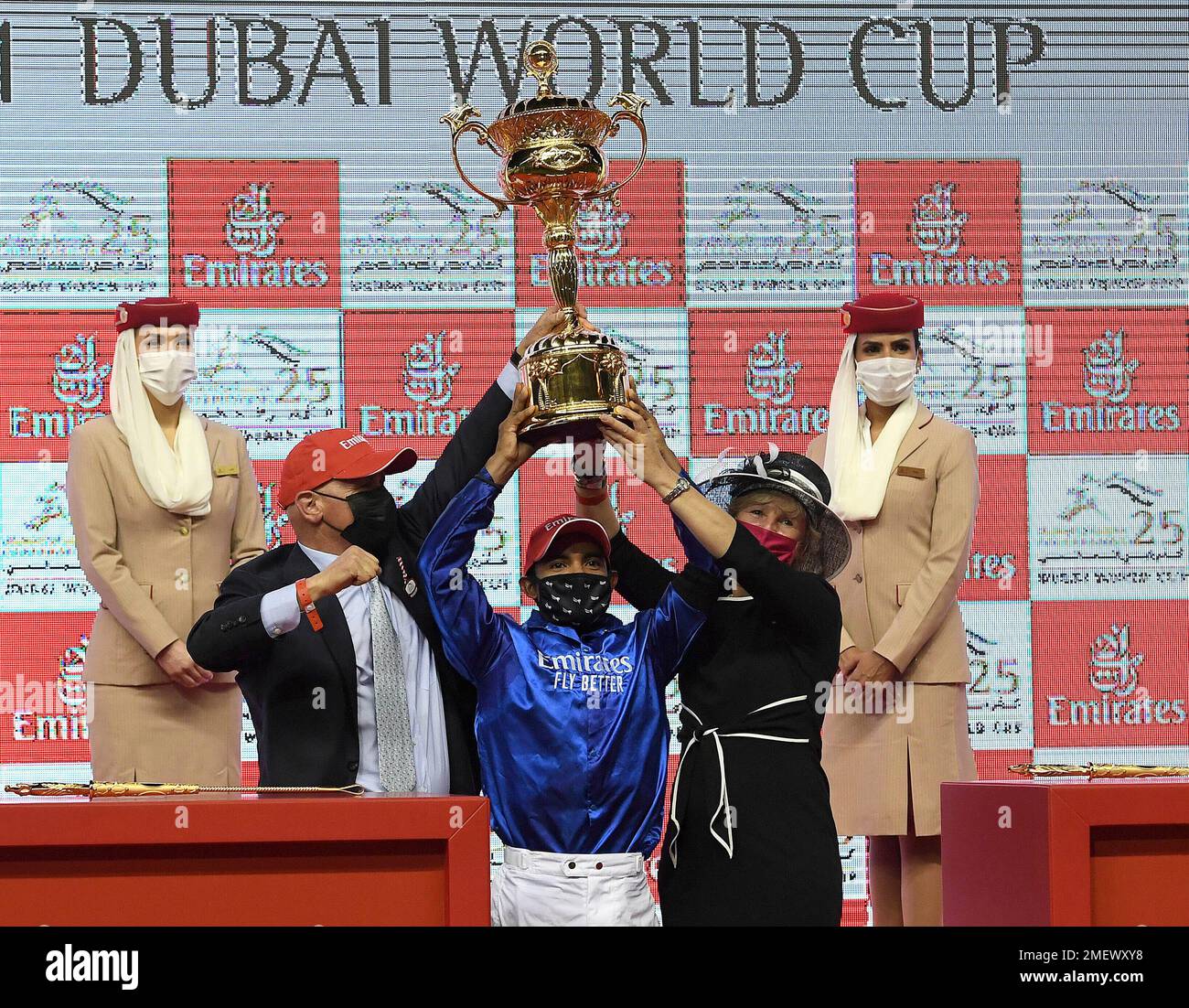 Mystic Guide's trainer Michael Stidham and jockey Luis Saez hold the ...