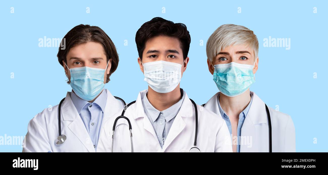 Multiethic team of doctors in medical face masks on blue Stock Photo ...