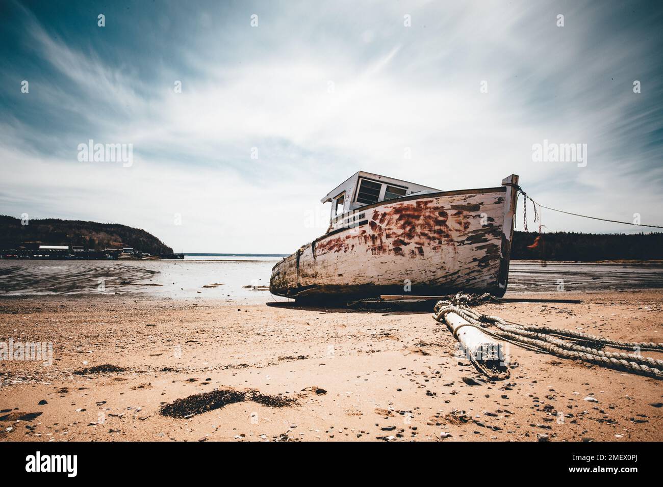 A beautiful view of a sandy beach with a boat on it in a sunny weather ...