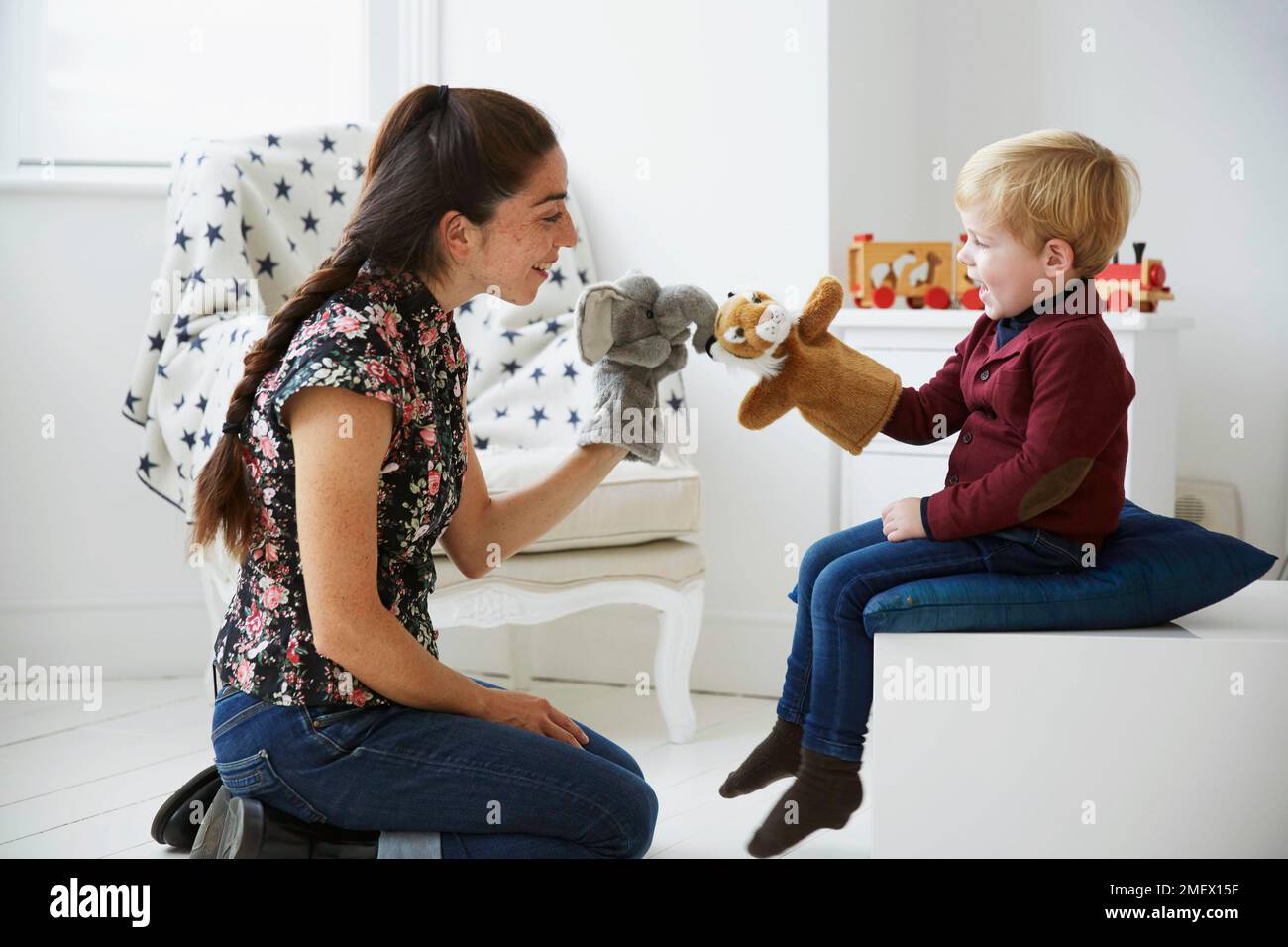 Mother and child playing with puppets (Model aged 3 Stock Photo - Alamy