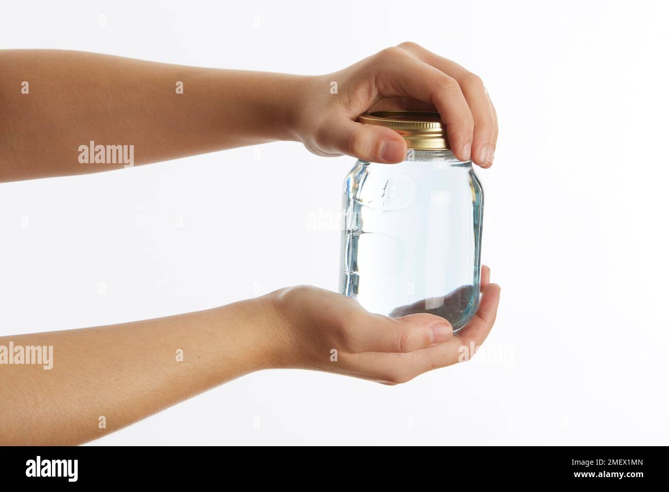 Tornado inside a glass jar, held in two hands Stock Photo - Alamy