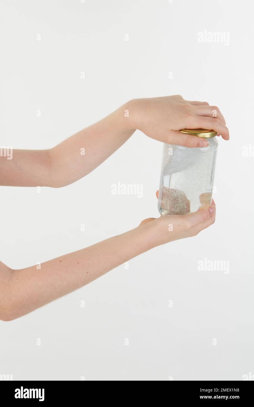 Holding glass jar hi-res stock photography and images - Alamy