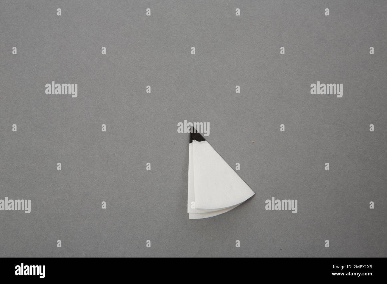 Folded filter paper with a circle of black ink in the centre Stock ...