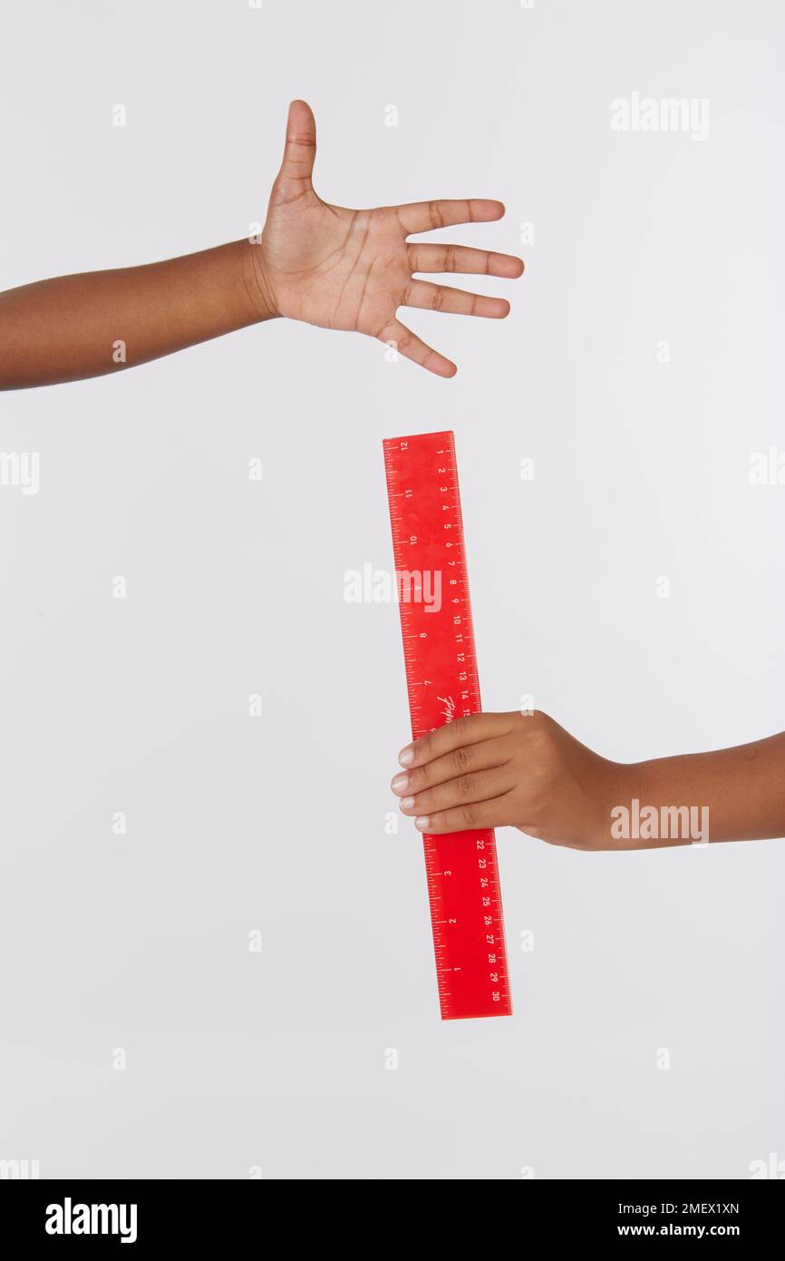 A red ruler is used to measure during a reactions test Stock Photo - Alamy
