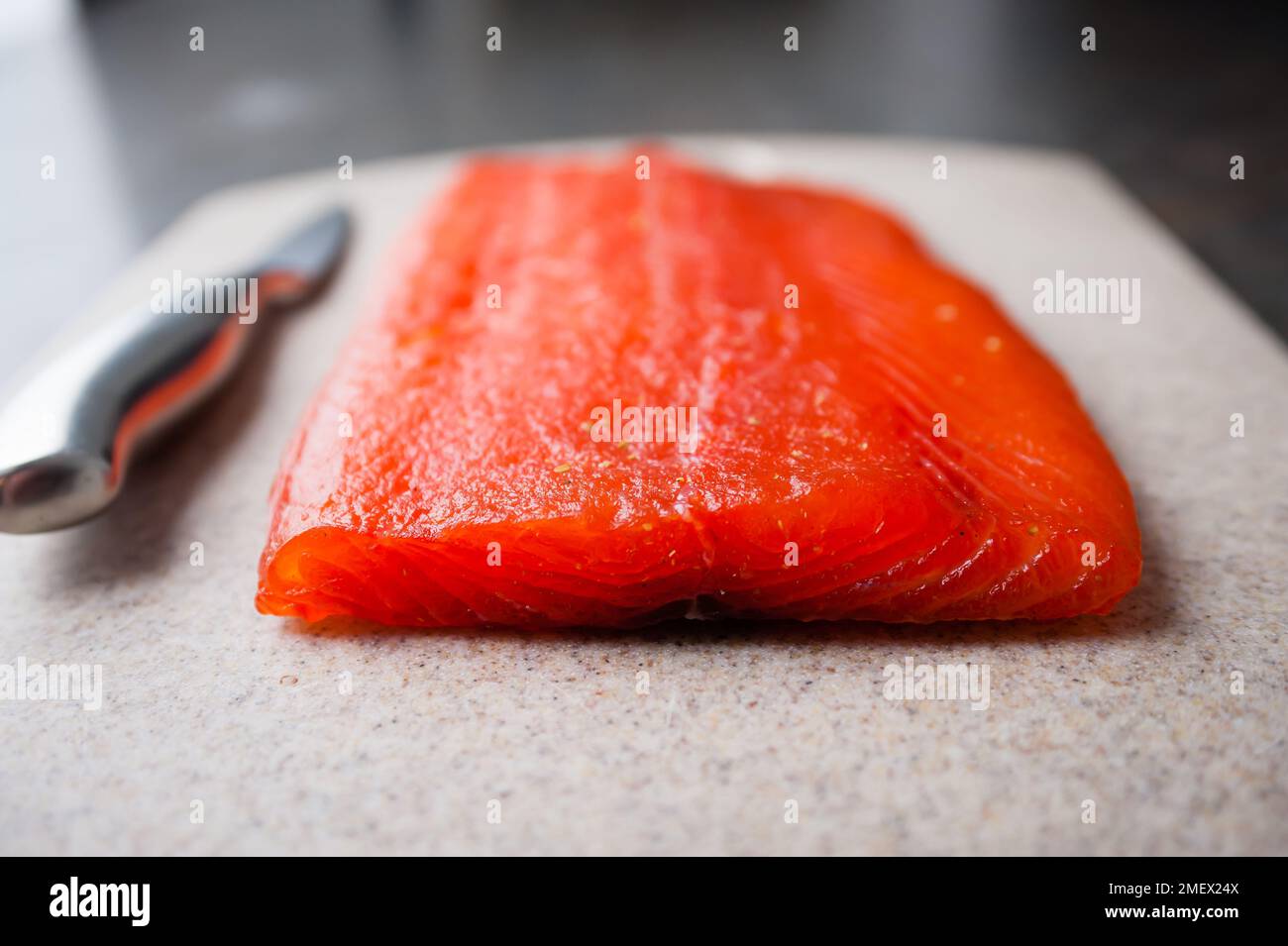 Curing fish, step 3: the cured fish on a chopping board, with a knife ...