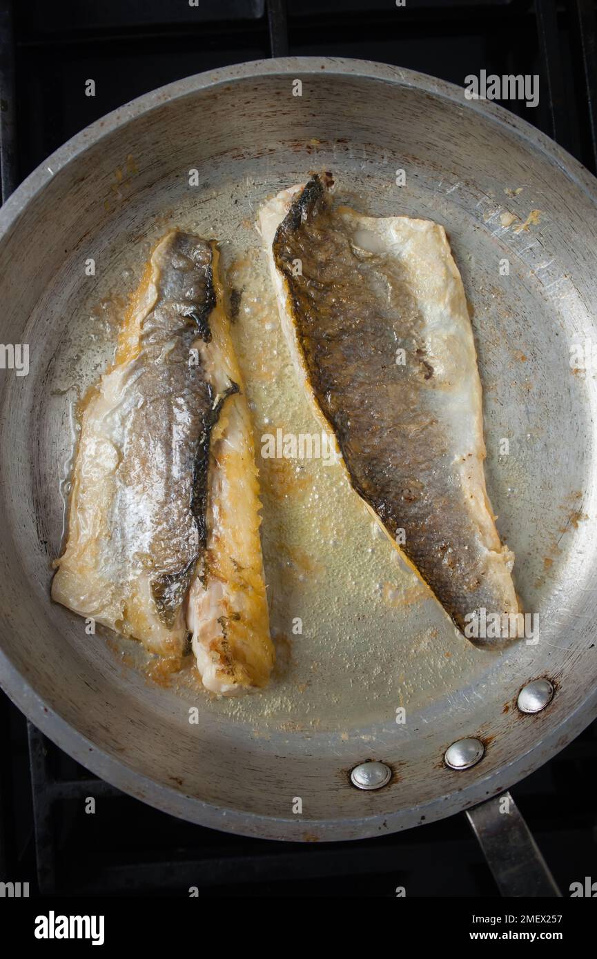 Crispy fish skin, step 3: turn the fish skin-side up and flatten with ...