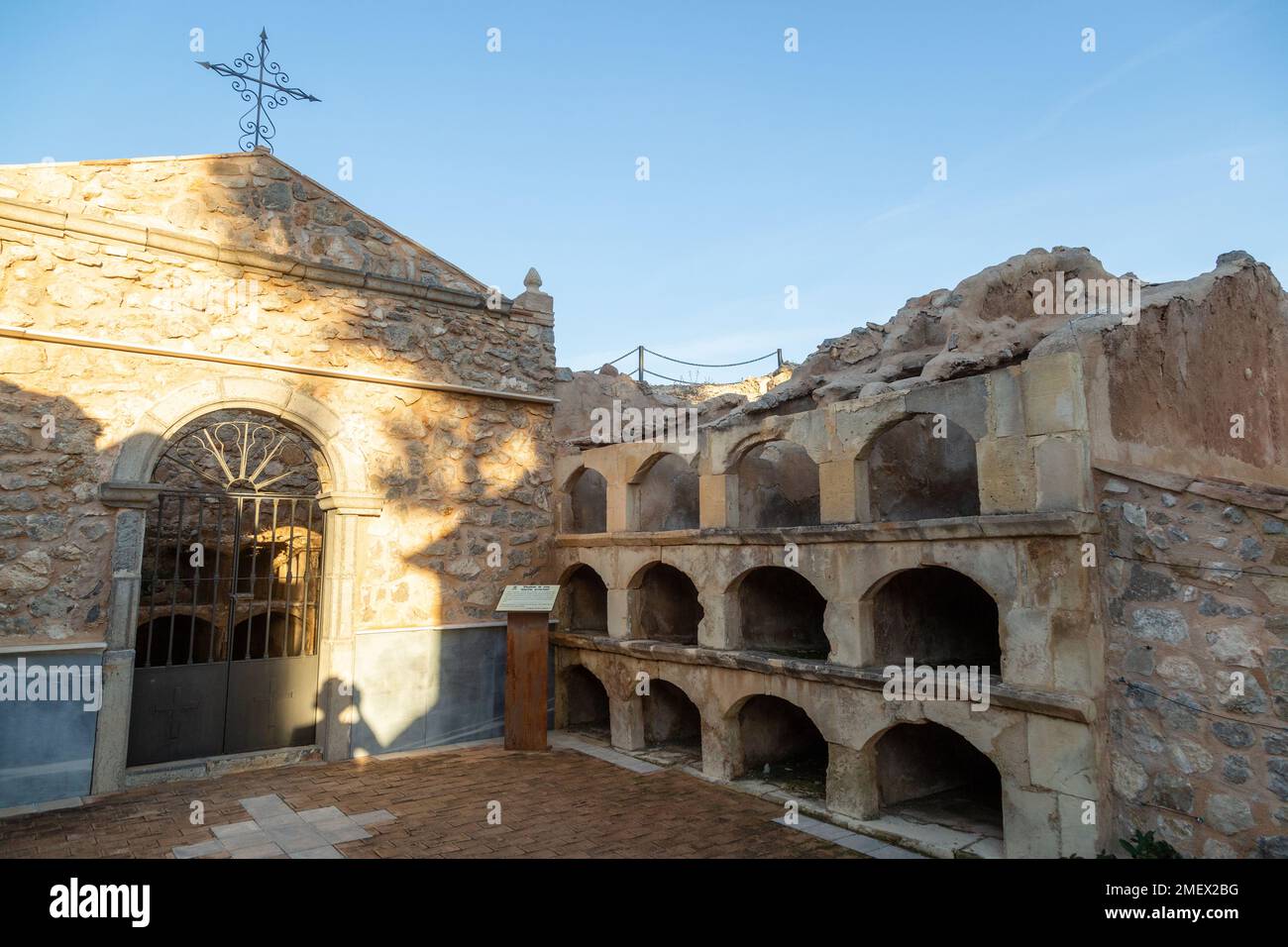 Burial crypts in the restored cemetery in the grounds of Polop Castle Stock Photo - Alamy