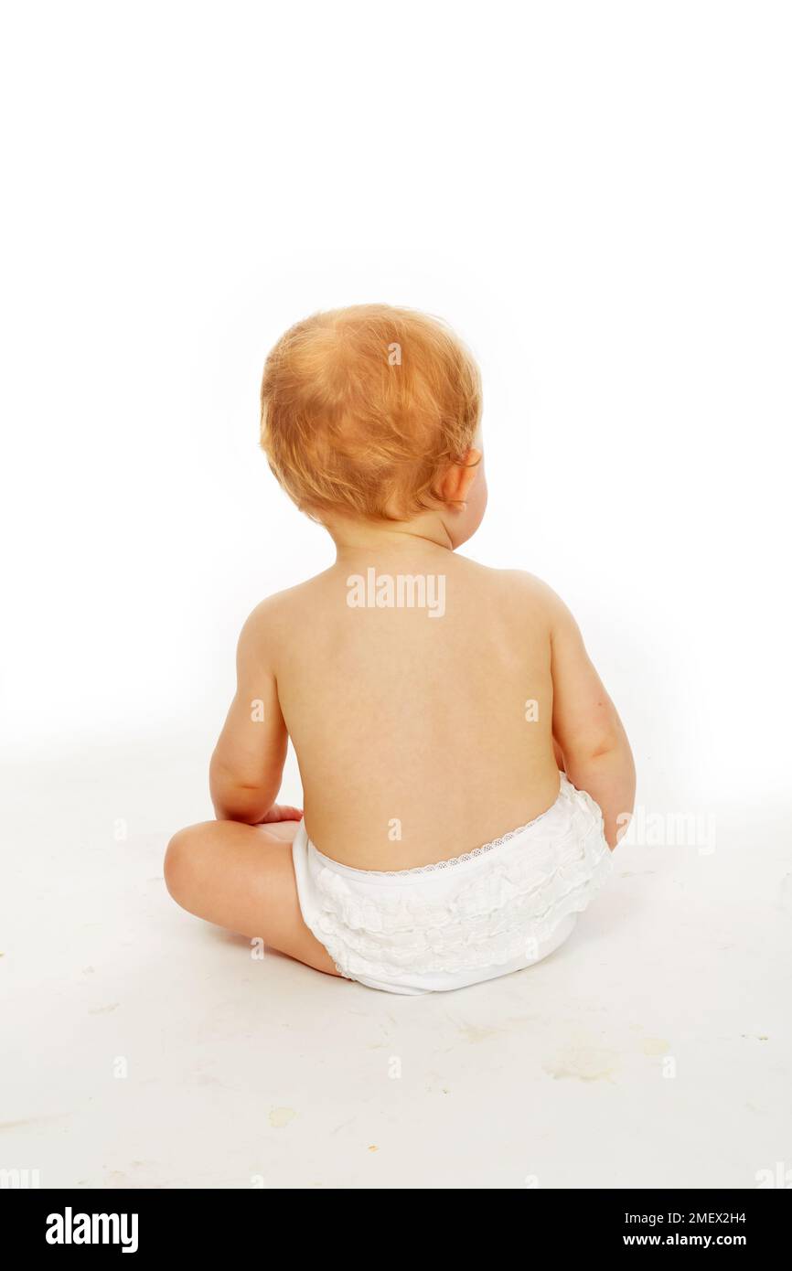 Baby in nappy sitting (Model age - 9 months Stock Photo - Alamy