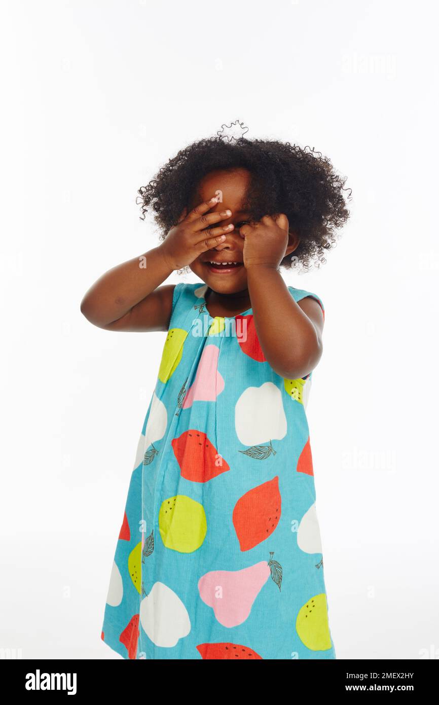 Little girl playing, hiding face (Model age - 2 years Stock Photo - Alamy